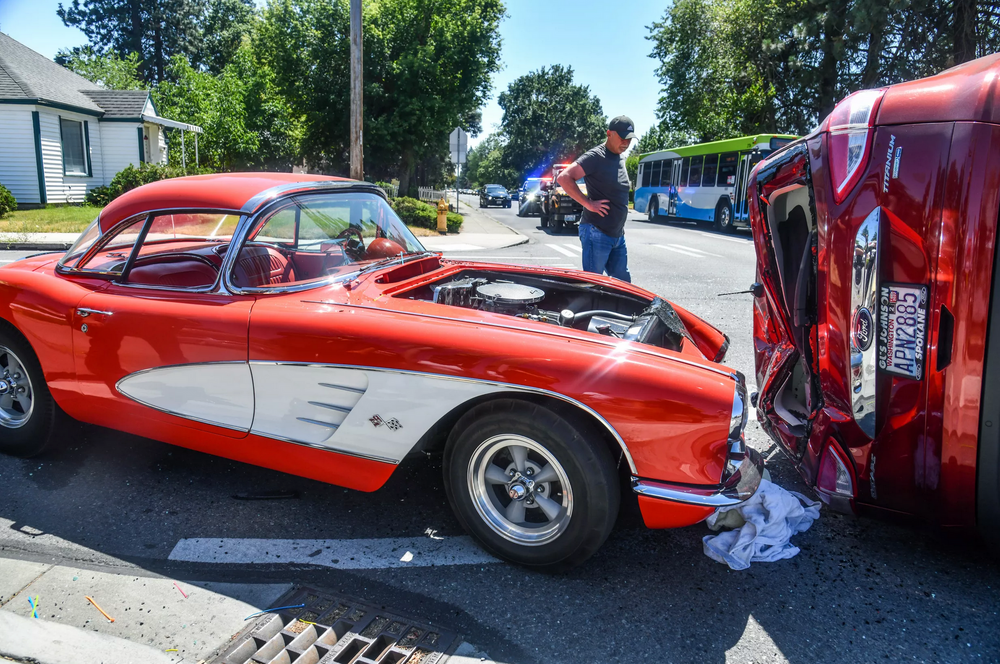 Little Red Corvette Gets Clipped By Rollaway SUV