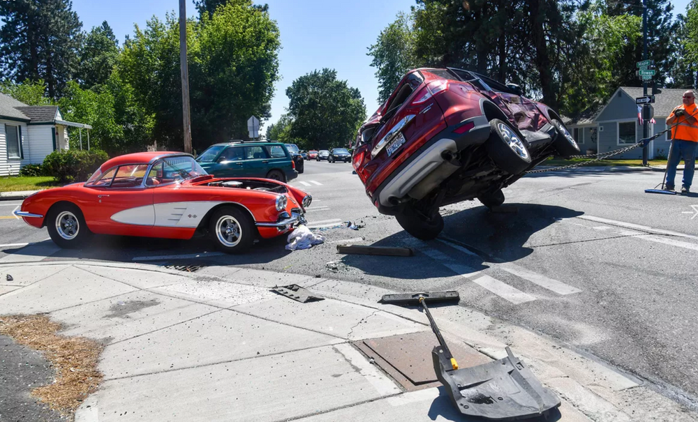 Little Red Corvette Gets Clipped By Rollaway SUV